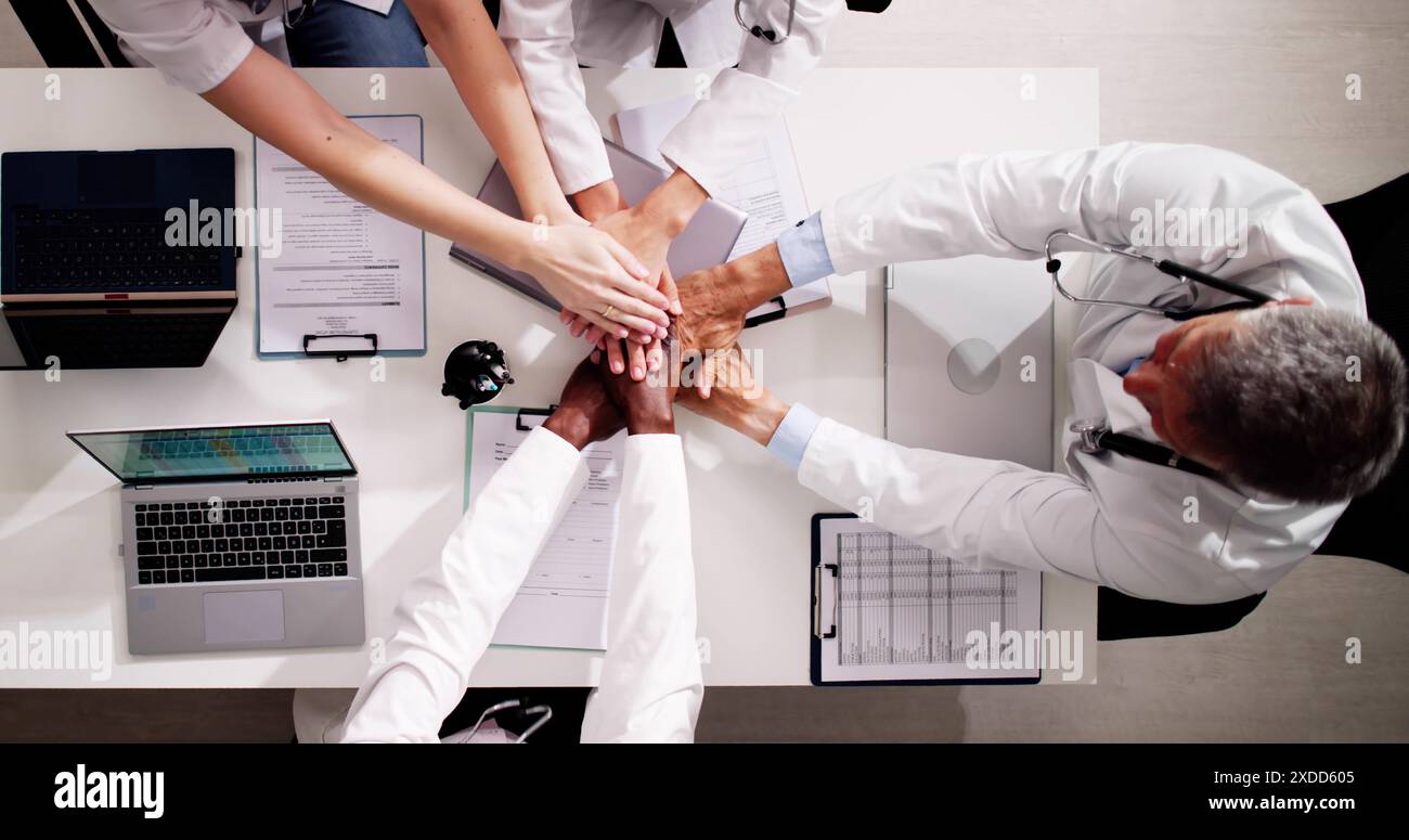Diverse Medical Team Staff Hands Stack At Desk Stock Photo - Alamy
