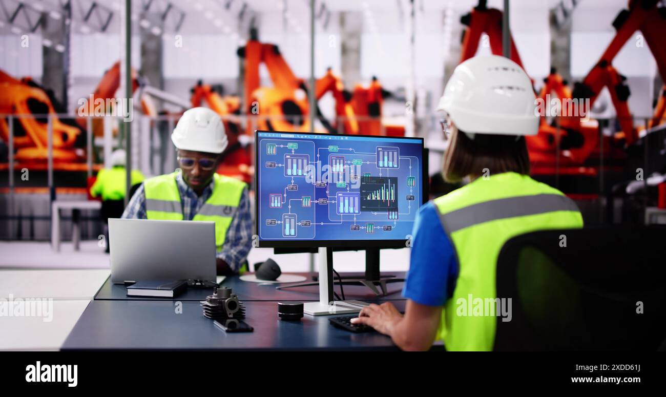 Engineer Using Computer In Electric Car Assembly Factory Stock Photo ...