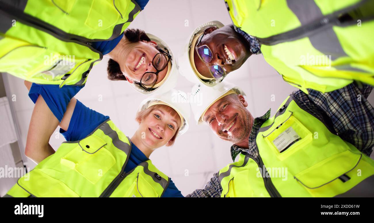 Multicultural Team Of Construction Workers In Hardhats Making Huddle Stock Photo - Alamy