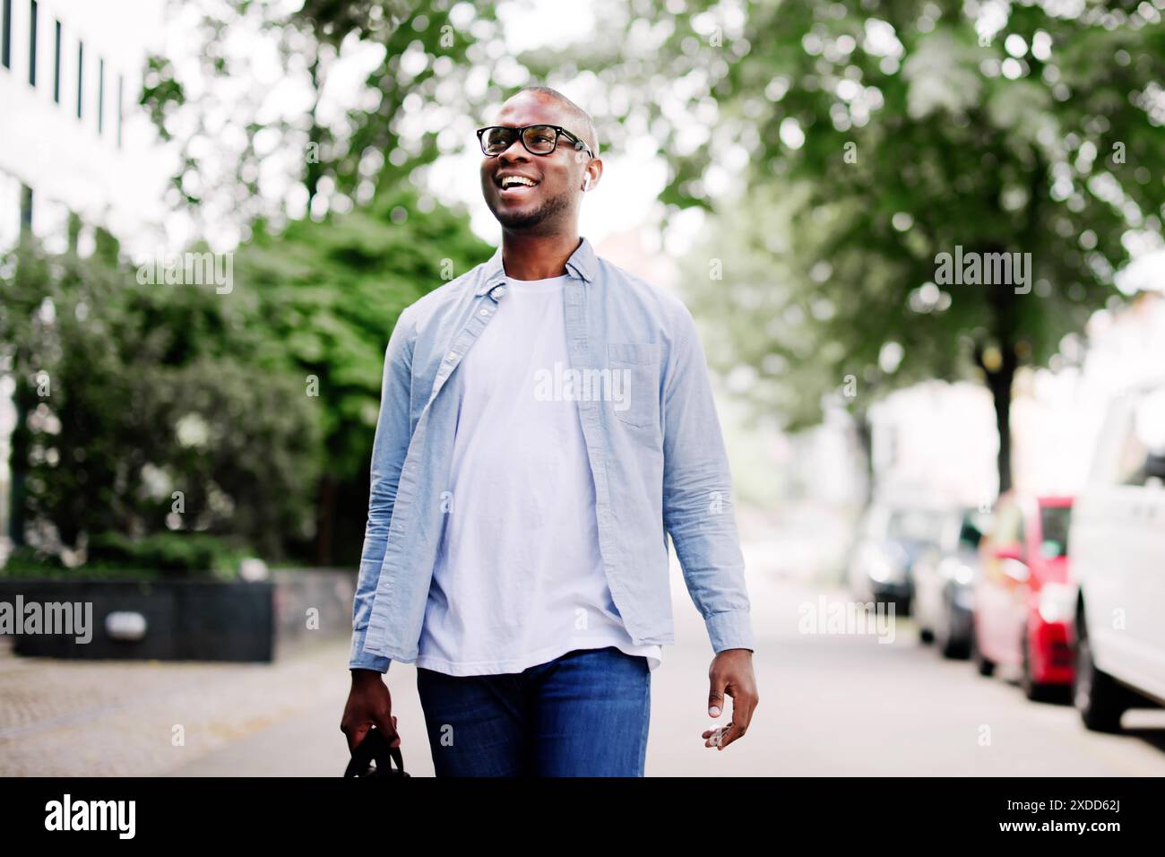 Digital marketer walking through busy city street connecting with ...
