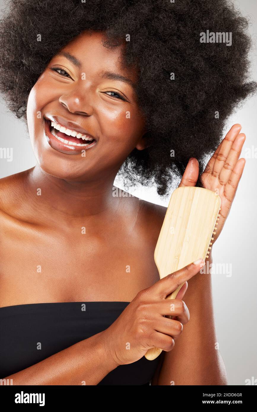 Happy, portrait and black woman with hair brush in studio for healthy ...