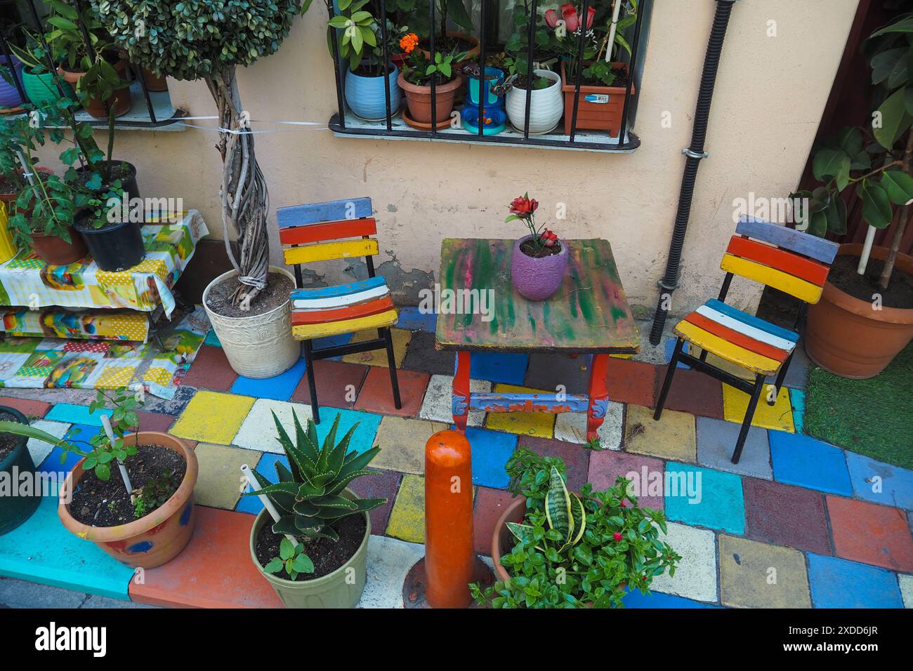 Colorful Outdoor Cafe Seating Area with Vibrant Potted Plants and ...