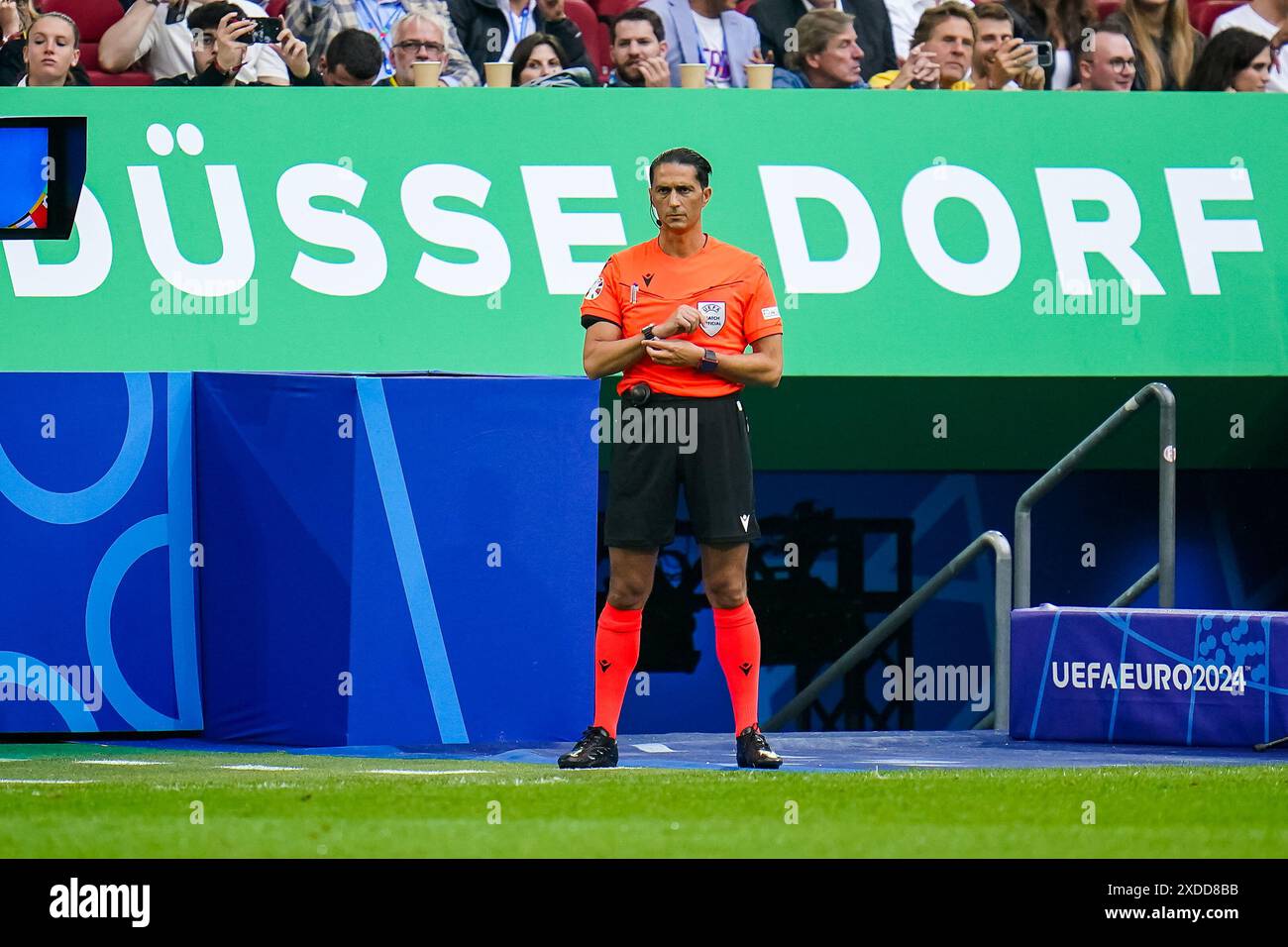 DUSSELDORF, GERMANY - JUNE 21: fourth official Serdar Gozubuyuk looks ...