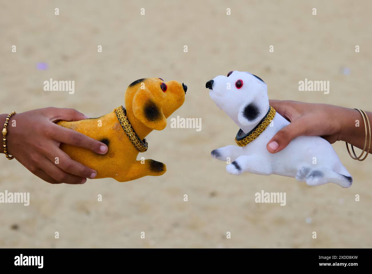Two hands hold plush dog toys, mimicking interaction. Golden retriever ...