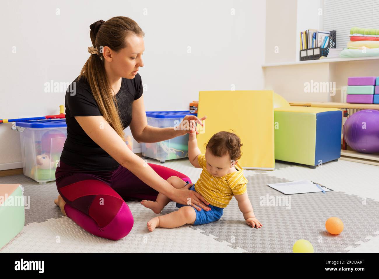 Little child patient is engaged in exercises to restore and improve ...