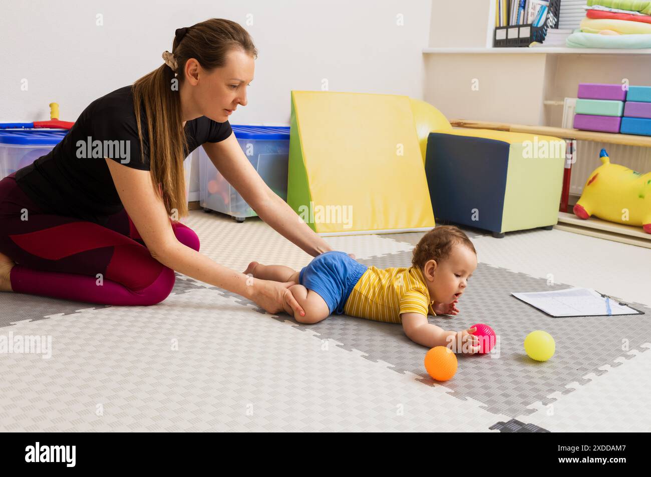 Little child patient is engaged in exercises to restore and improve ...