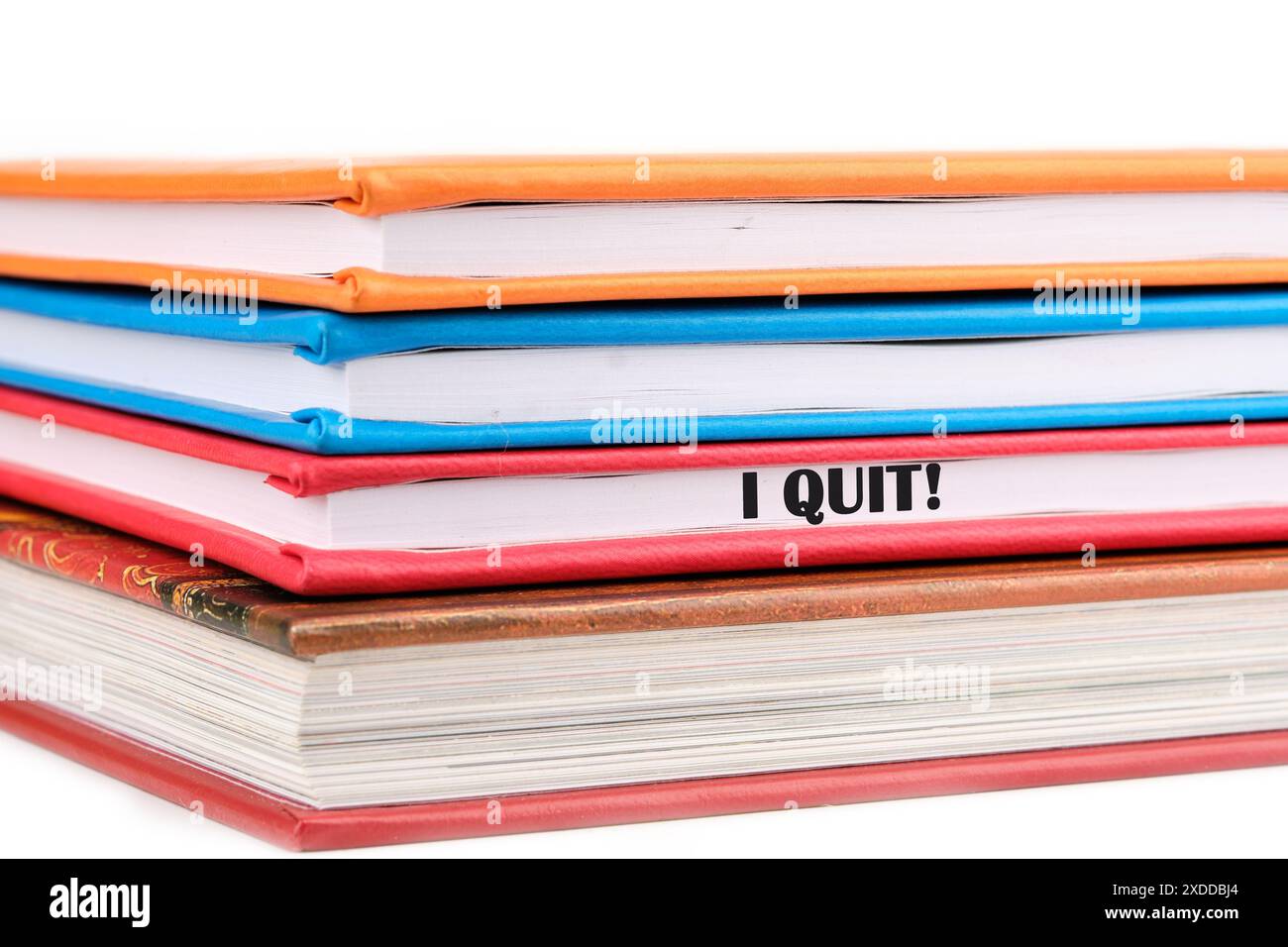 Business text. I Quit word on the ends of notebooks lying on top of ...