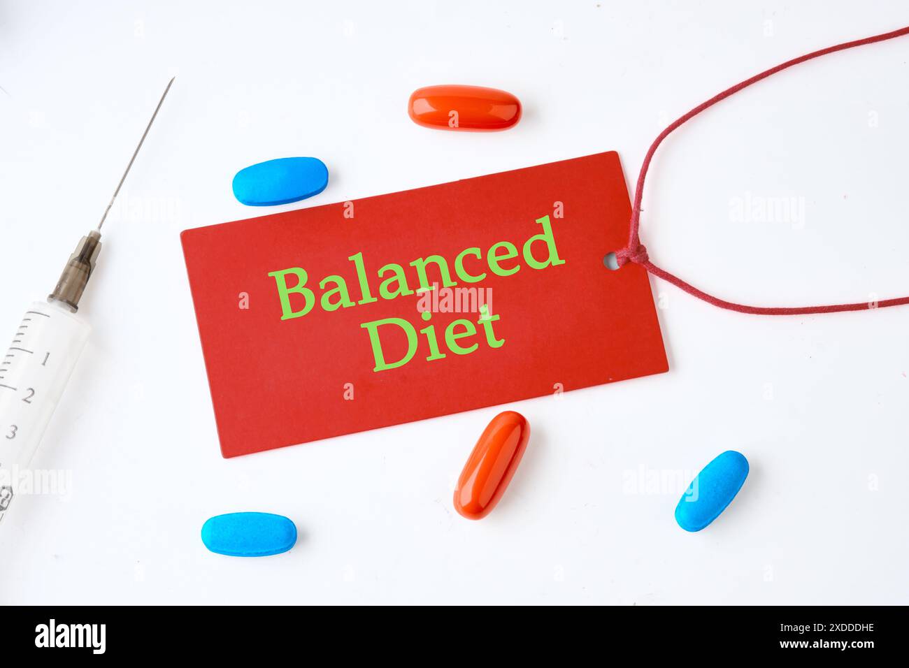 Balanced Diet text written on a red card on a light background with ...