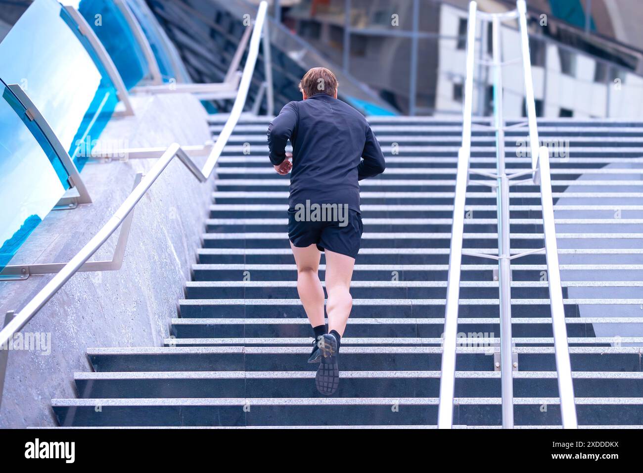 Athlete, running down the stairs, doing dynamic exercise outdoors Stock ...