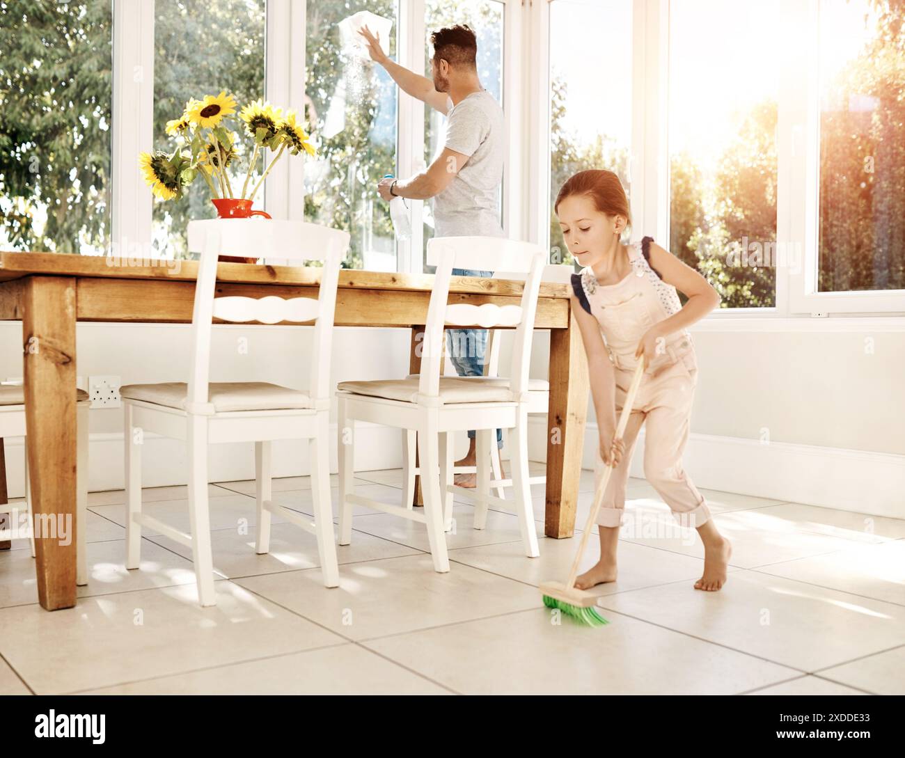 Cleaning, father and daughter in kitchen of house, sweeping and washing ...