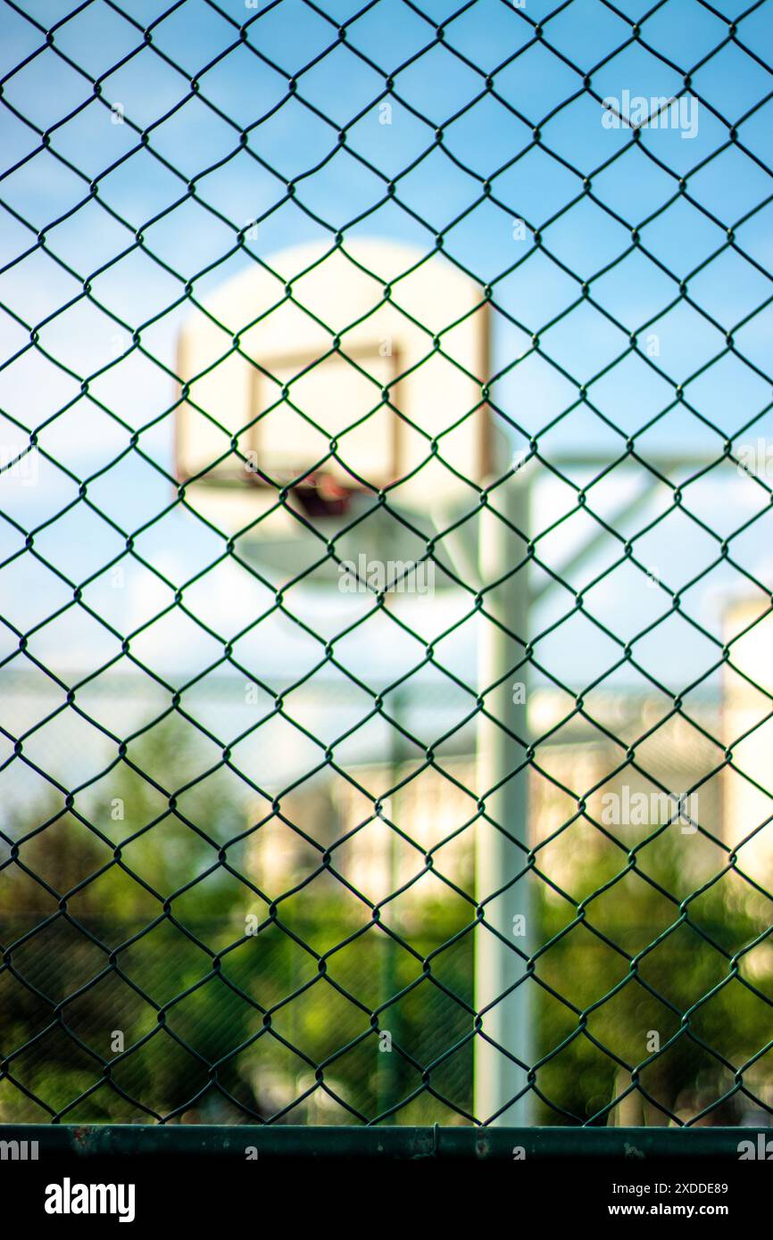 Basketball hoop behind a fence, perfect for backgrounds and wallpapers ...