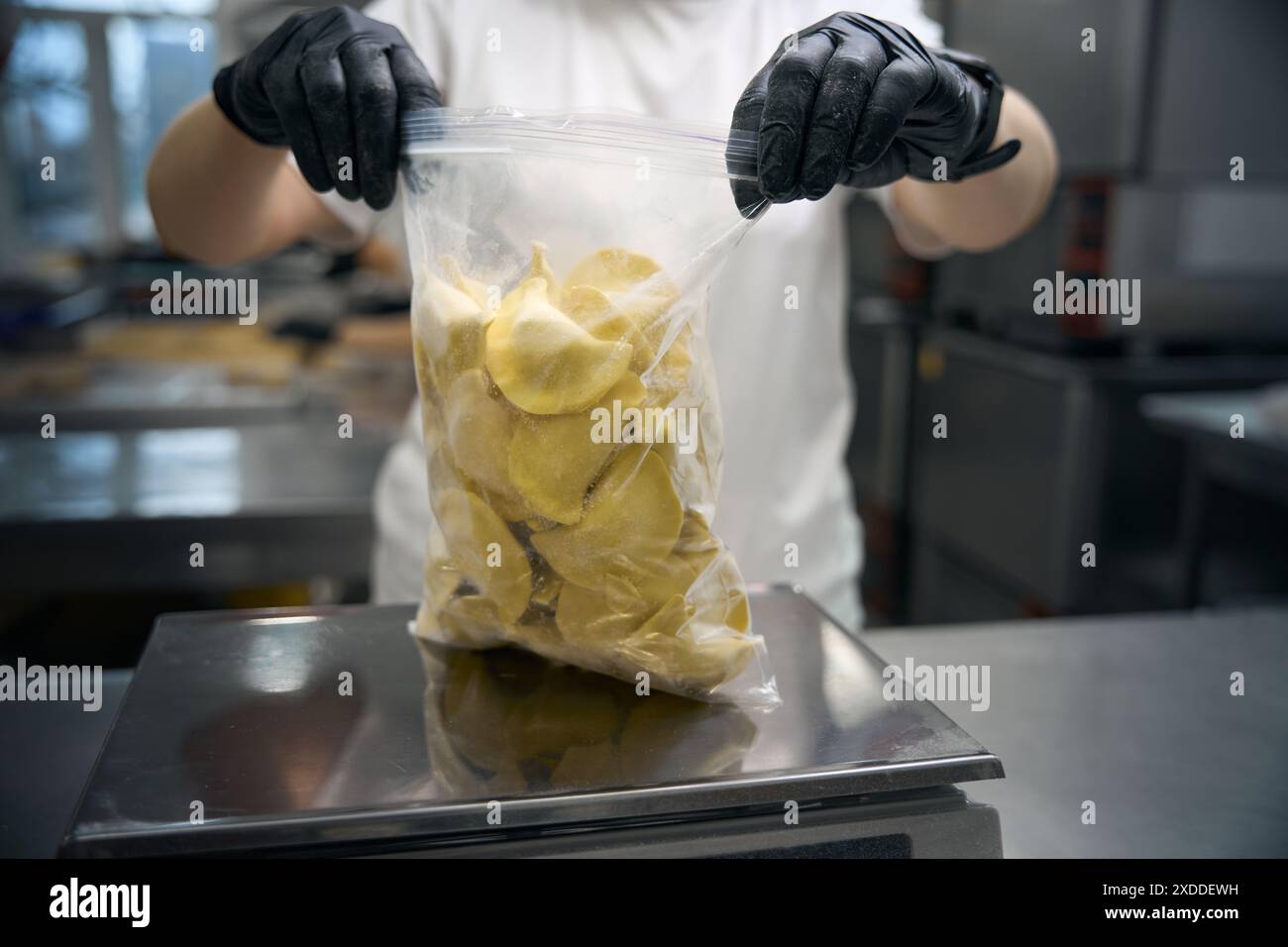 Female weighs a package of frozen dumplings Stock Photo - Alamy