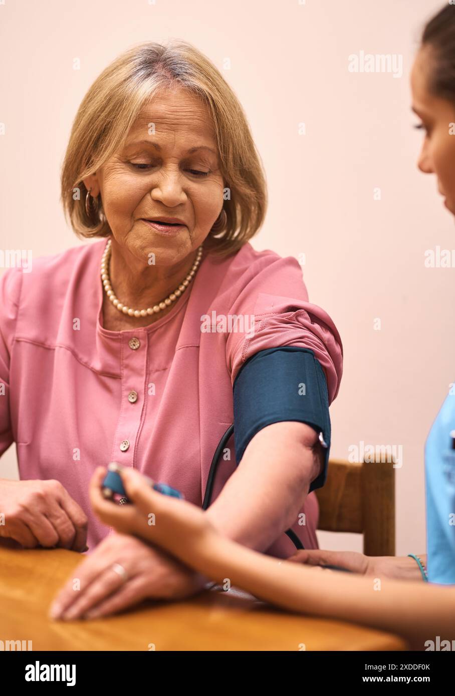 Heart rate, nurse and senior woman in house for healthcare test at ...