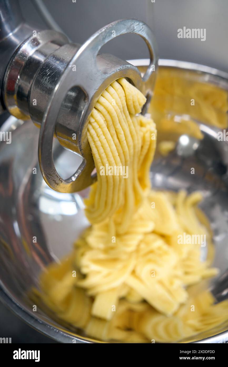 Process of grinding boiled potatoes in a meat grinder Stock Photo - Alamy