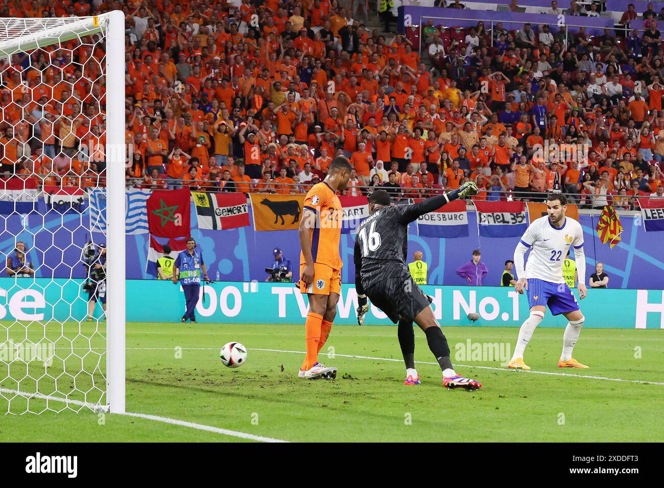 Goalkeeper Mike Maignan of France (C) is obstructed by Denzel Dumfries ...