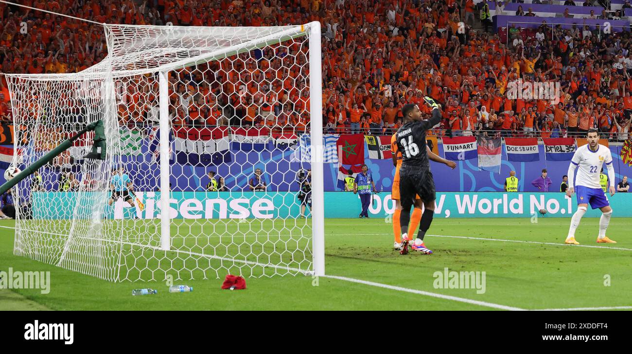 Goalkeeper Mike Maignan of France (C) is obstructed by Denzel Dumfries ...