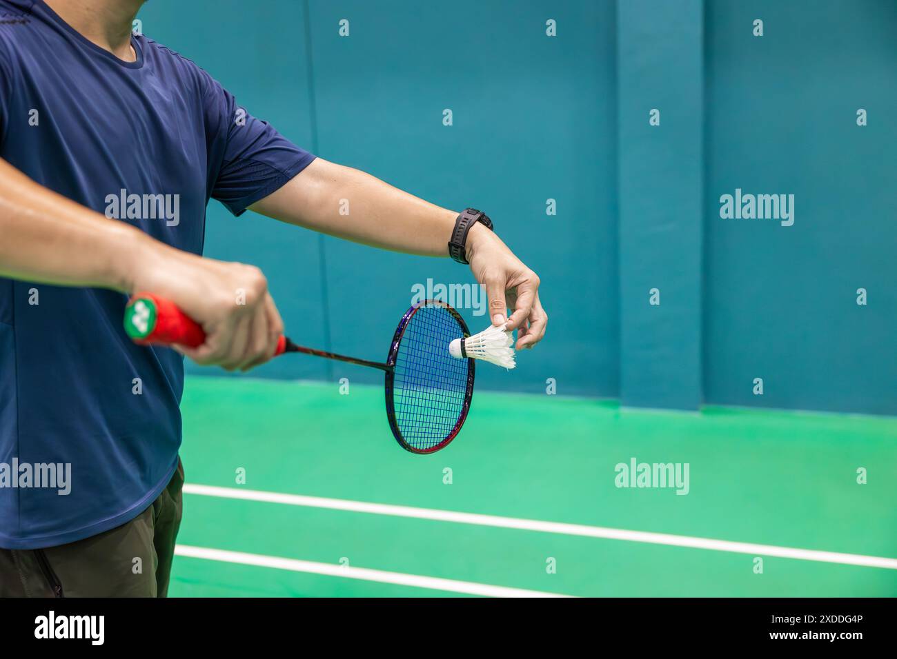 Badminton player hand serving holding shuttlecock and professional ...