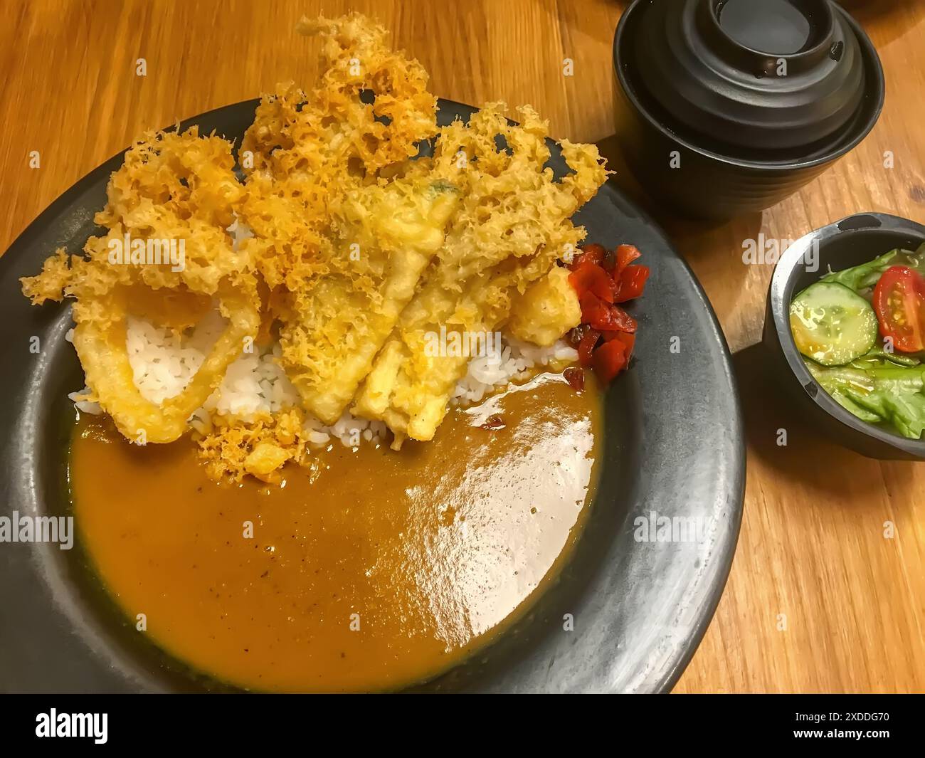 Golden tempura atop Japanese curry rice Stock Photo - Alamy