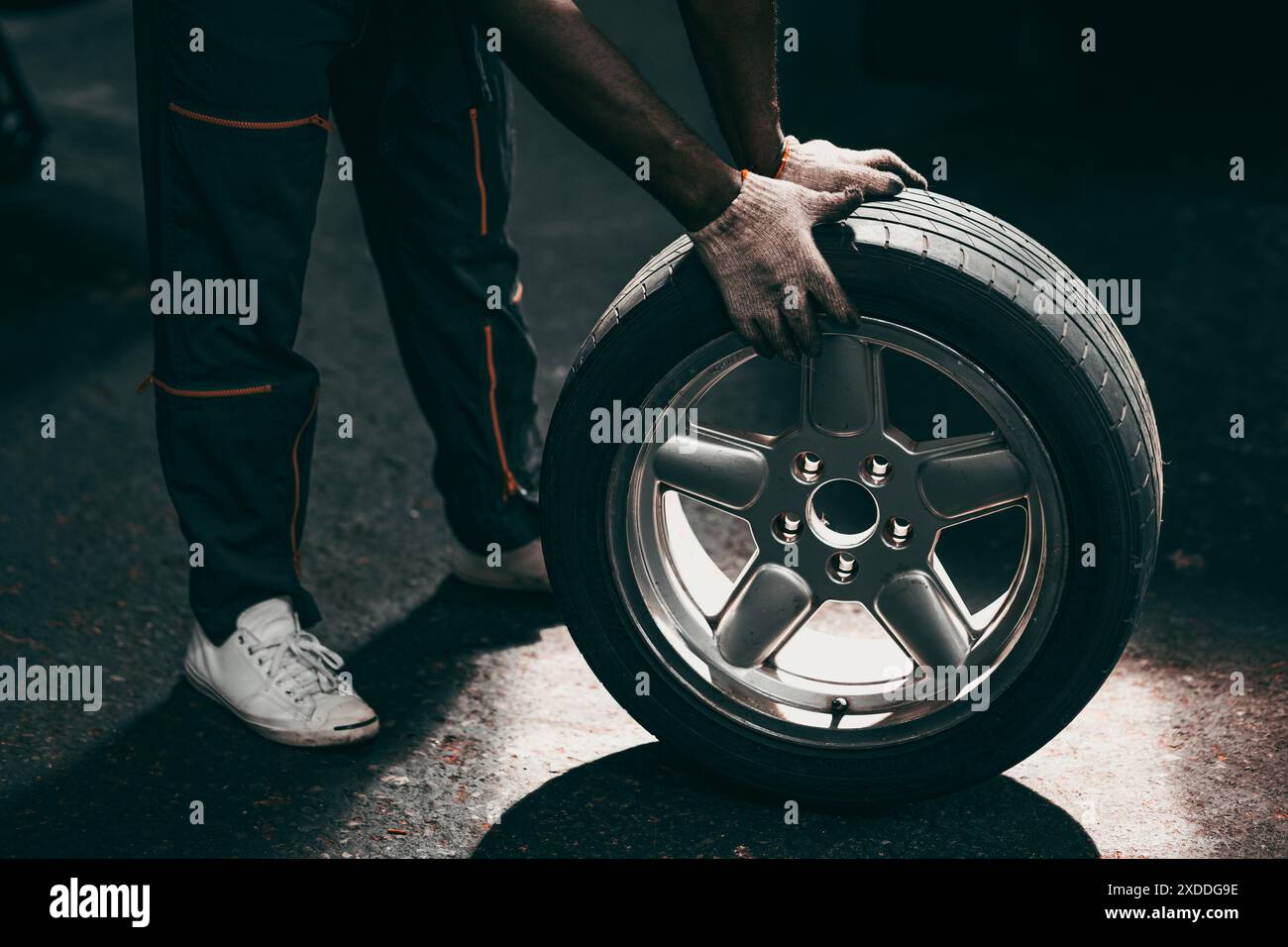 Garage car mechanic changing tyre hi-res stock photography and images ...