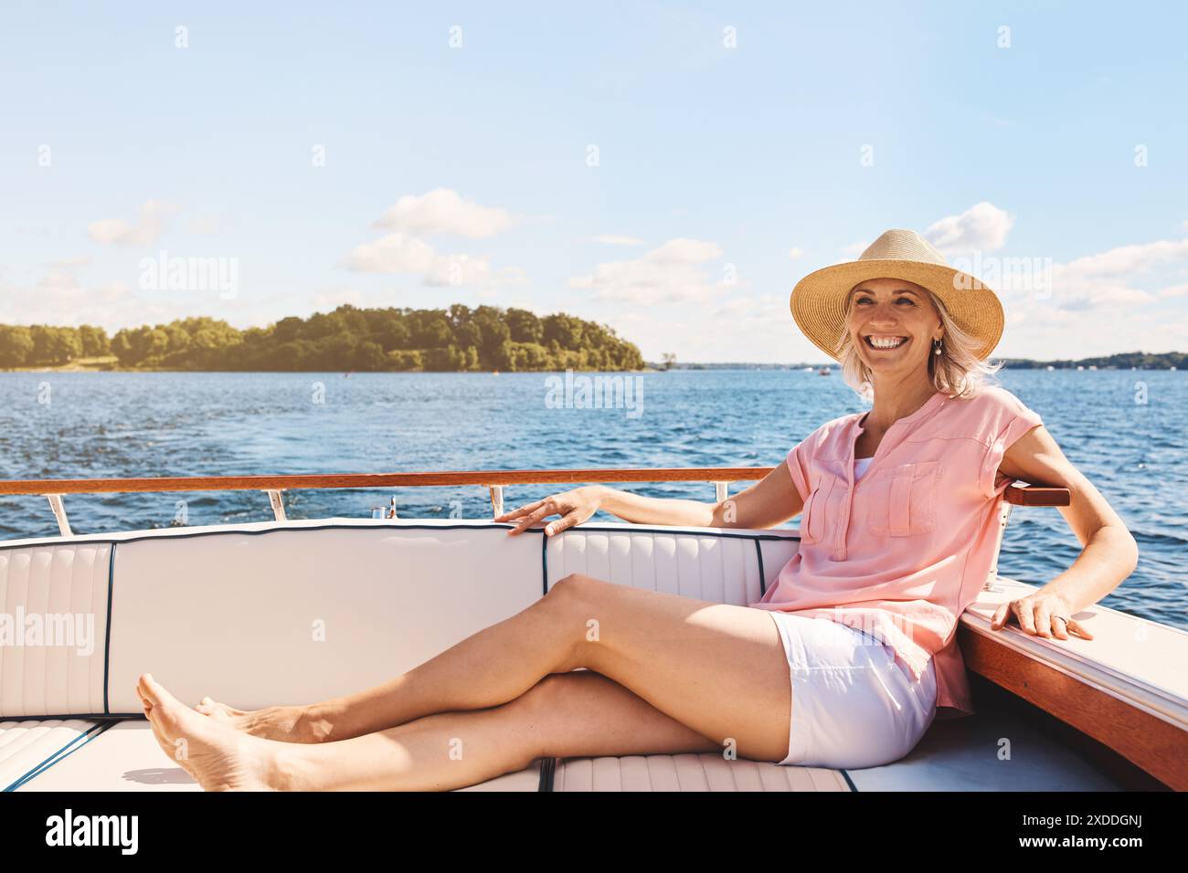 Vacation, blue sky and freedom for mature woman on boat for sailing ...