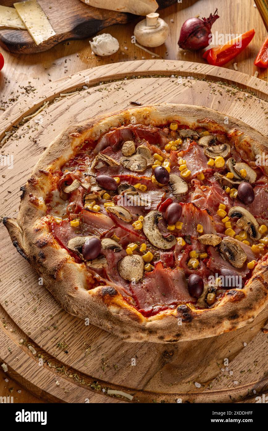 Homemade Capricciosa pizza made of cheese, mushrooms, olives and ham ...