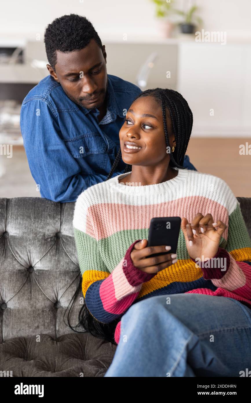 Couple using smartphone talking sitting hi-res stock photography and ...