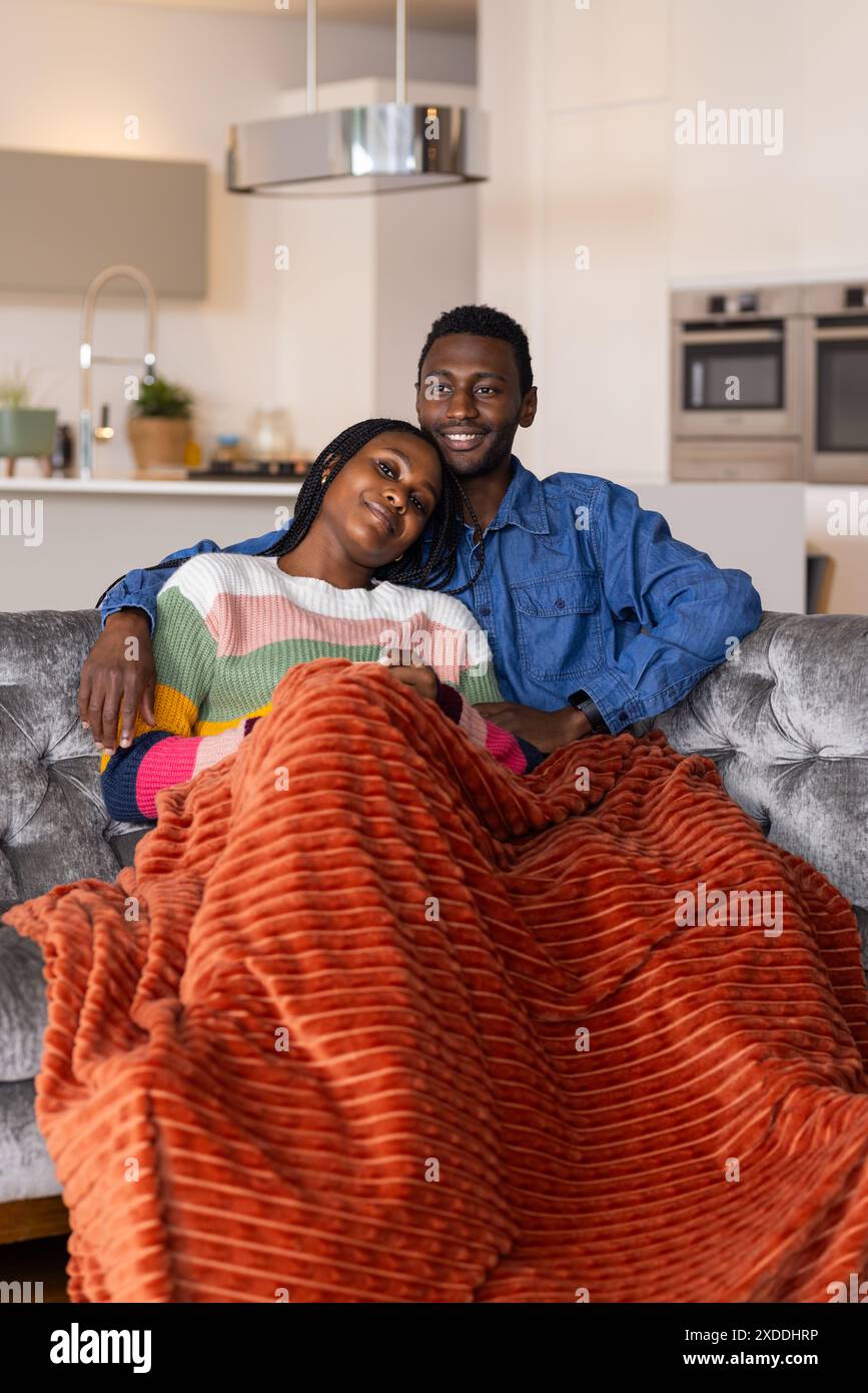 Couple snuggling on couch hi-res stock photography and images - Alamy