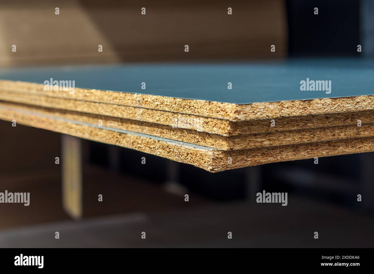 Close-up of particleboard sheets with smooth surfaces, stacked for ...