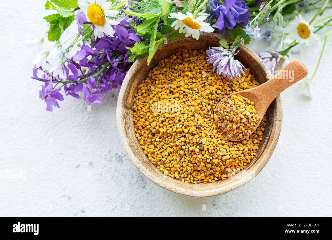 Healthy bee pollen grains. Bee pollen on a bowl and wild flowers Stock ...