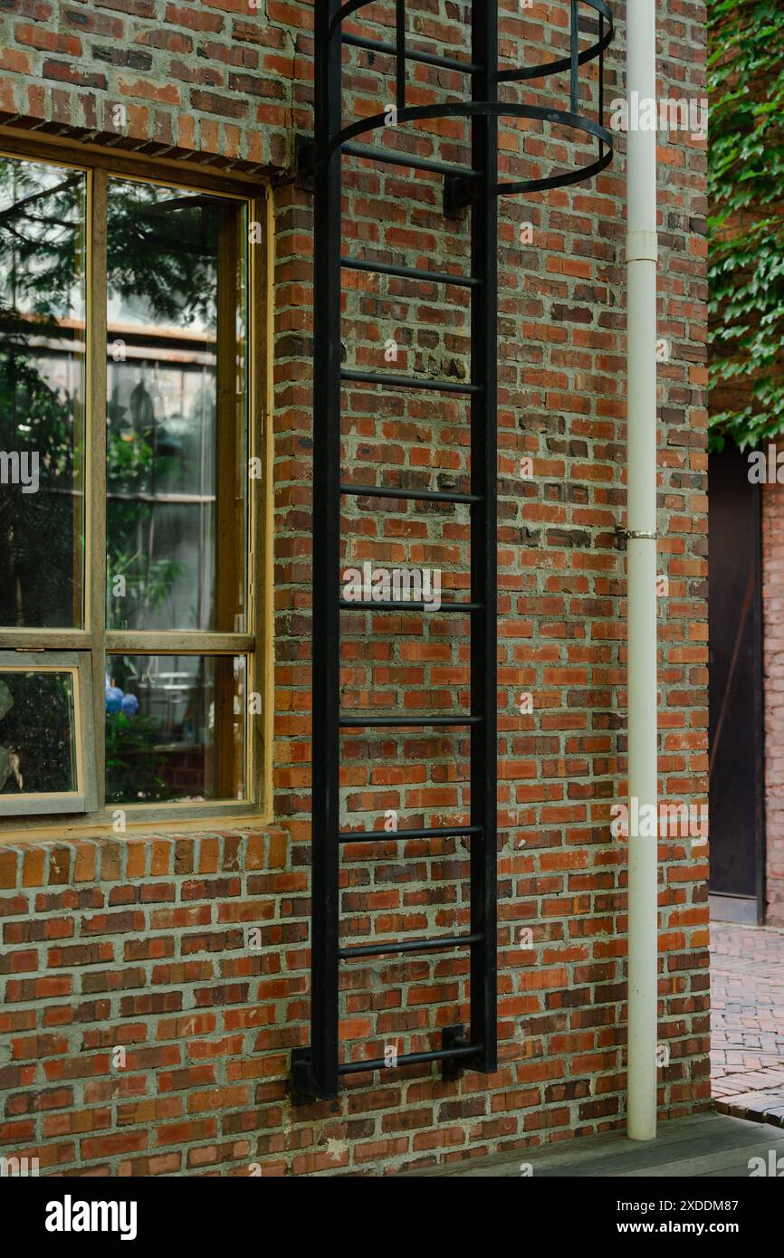 Fire Escape Ladder on Brick Wall with Window Stock Photo - Alamy