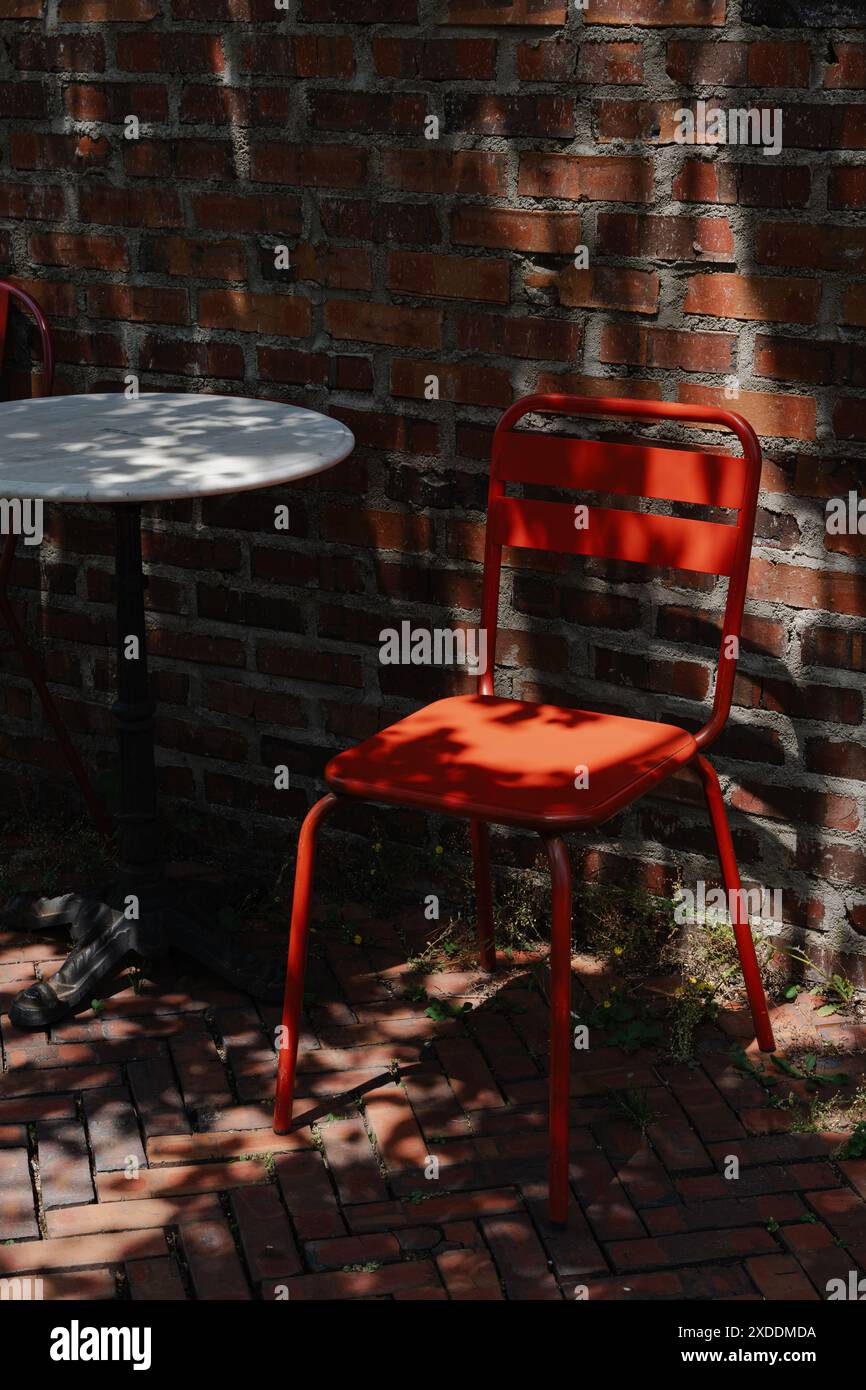 Outdoor Seating with Red Chair and Brick Wall Background Stock Photo ...