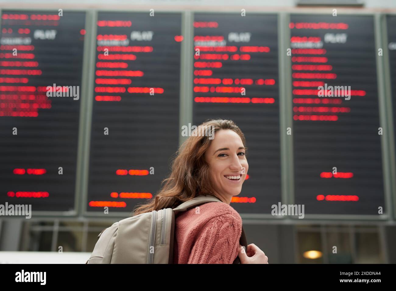 Woman, portrait and airport with flight schedule on board for info ...