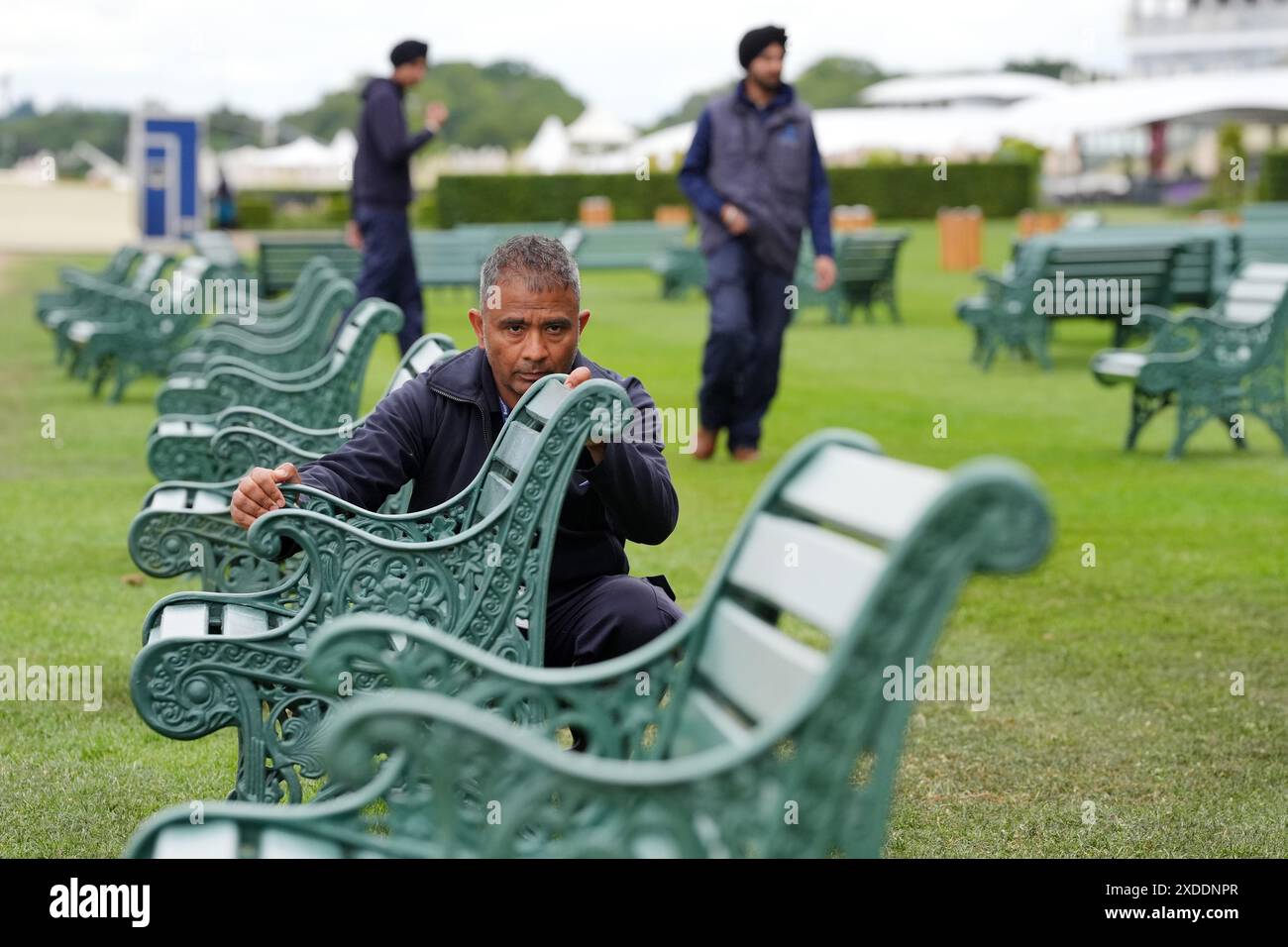 Ground staff line up the benches in front of the grandstand before day ...