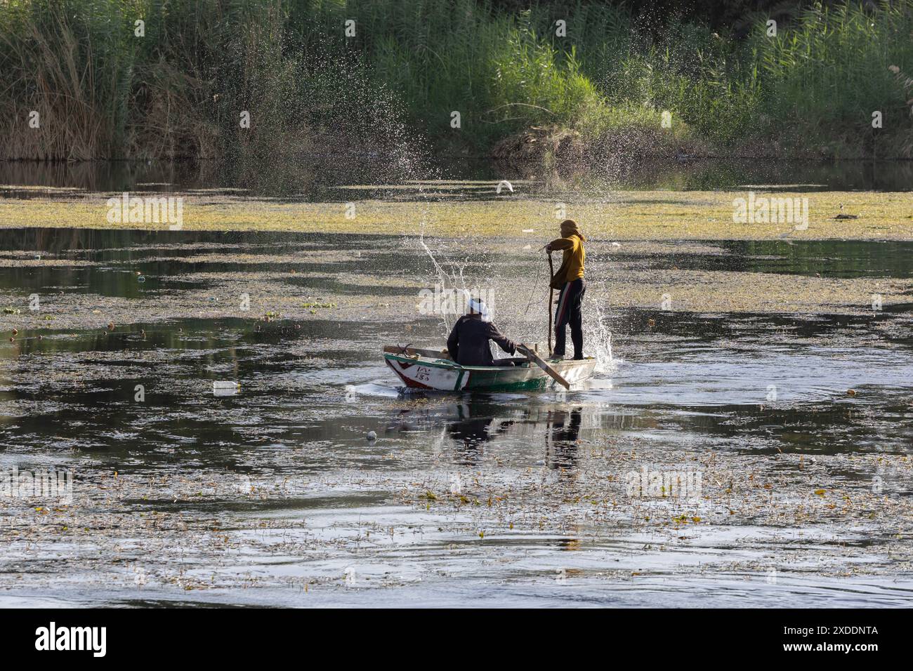 Fishermen in a halo of spray on the Nile River between Esna and El-Kab ...