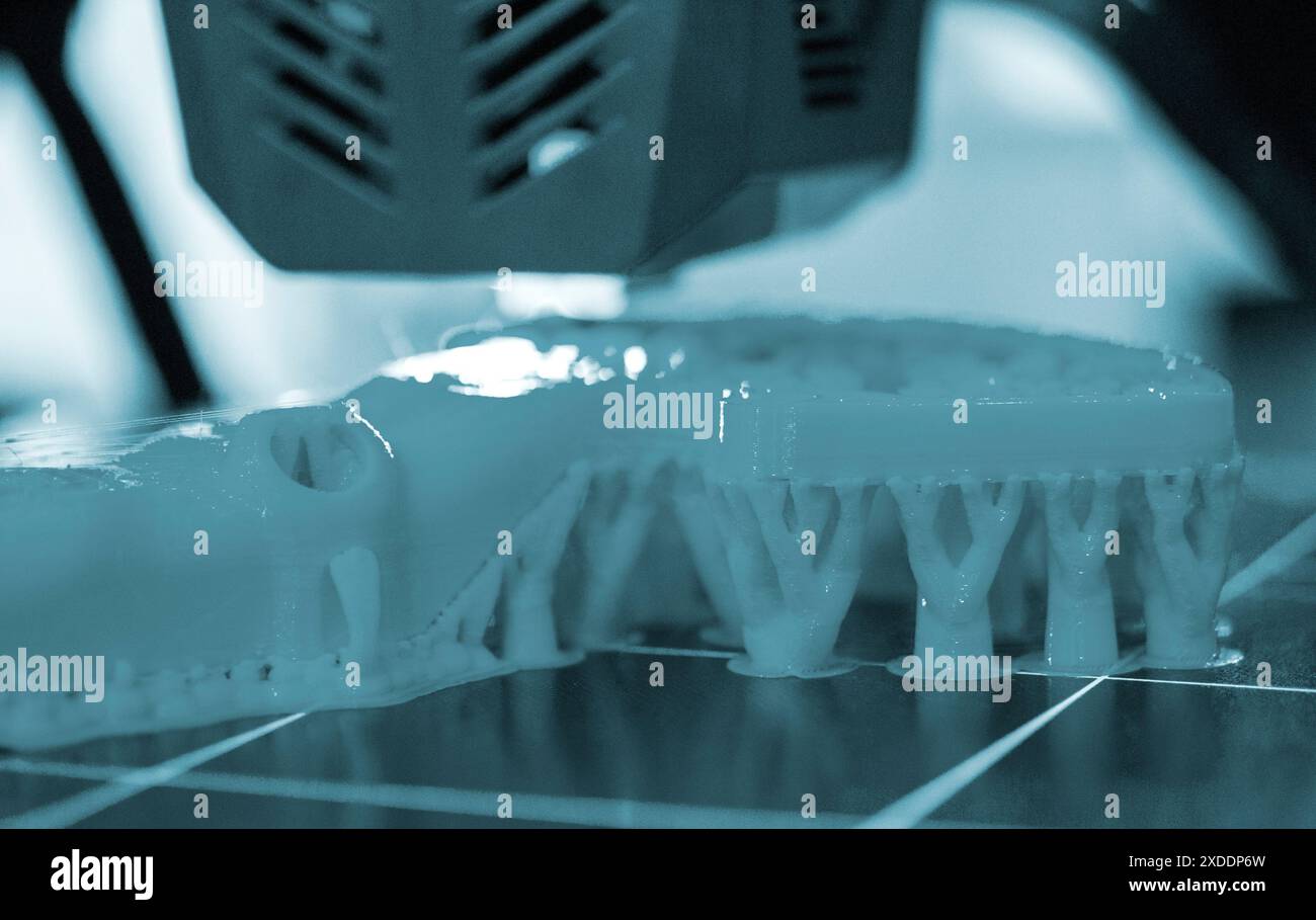 3D printer close up. A working 3D printer in process of printing object ...