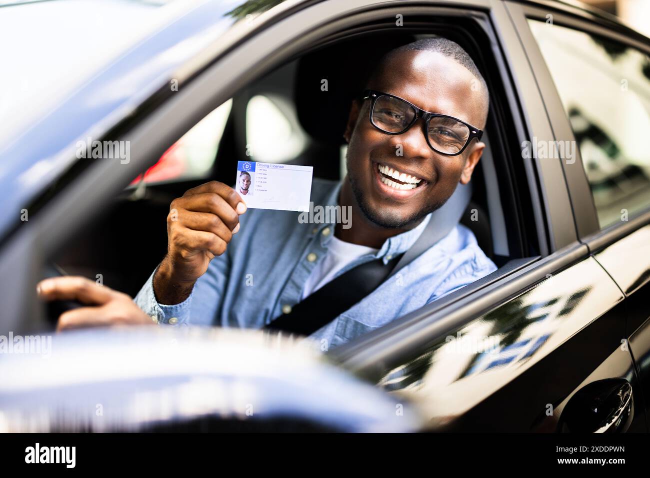 Successful businessman completes driving test and proudly displays new ...