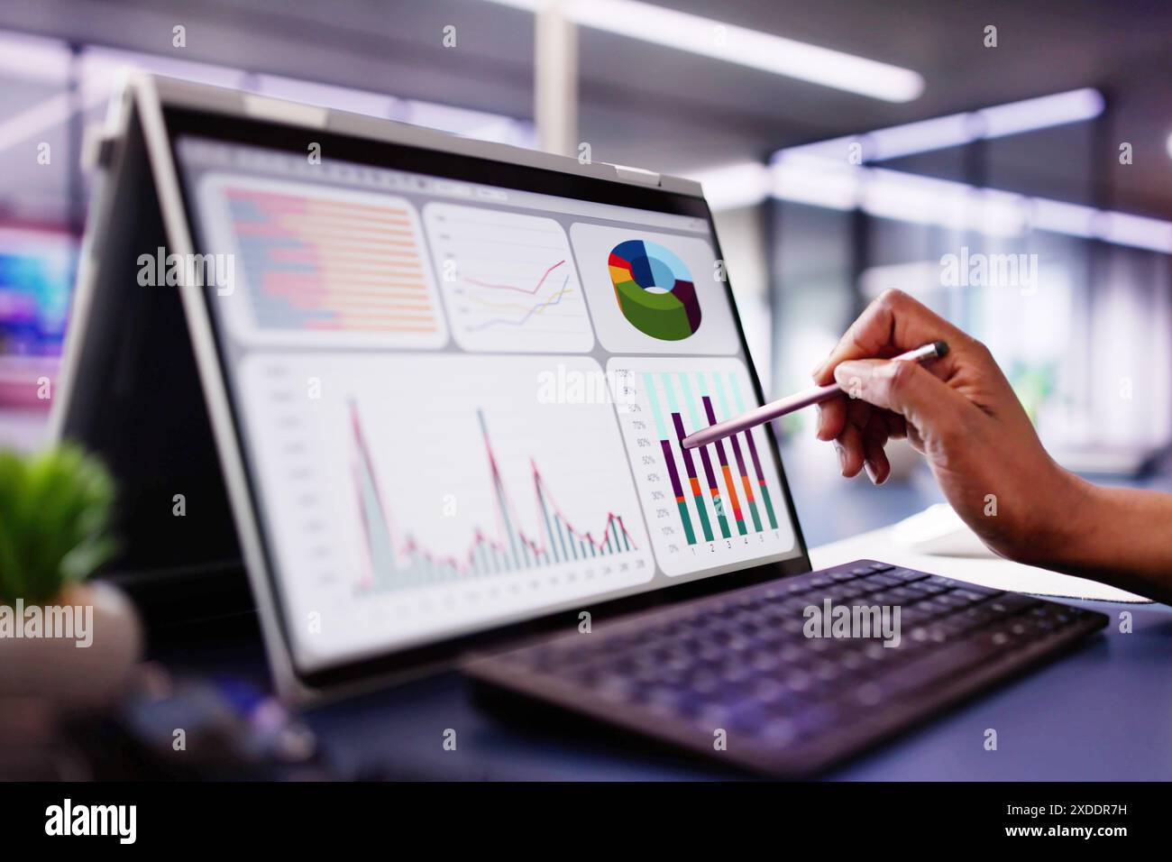African American woman analyzing financial data on laptop screen in ...