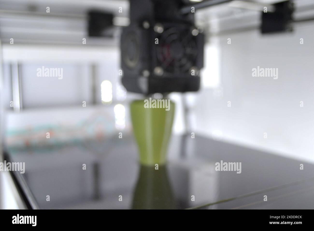 3D printer close up. A working 3D printer in process of printing object ...