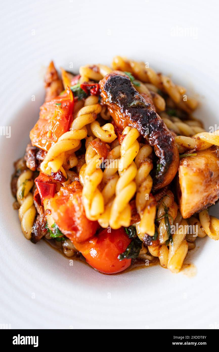 Sautéed octopus, gemeli, mini chucha tomatoes Stock Photo - Alamy
