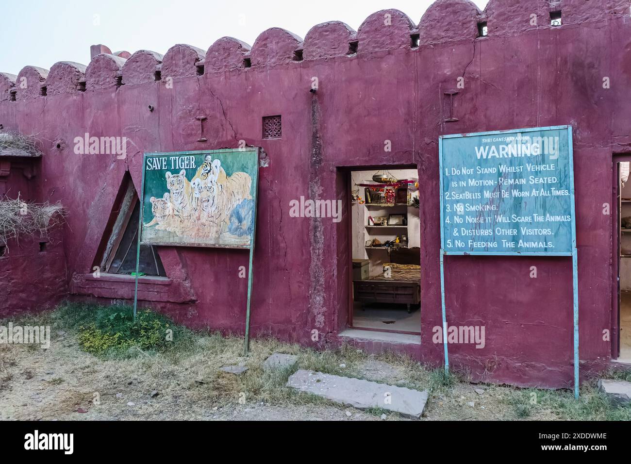 Safari behaviour warning sign and a faded 'Save Tiger' painting sign at ...