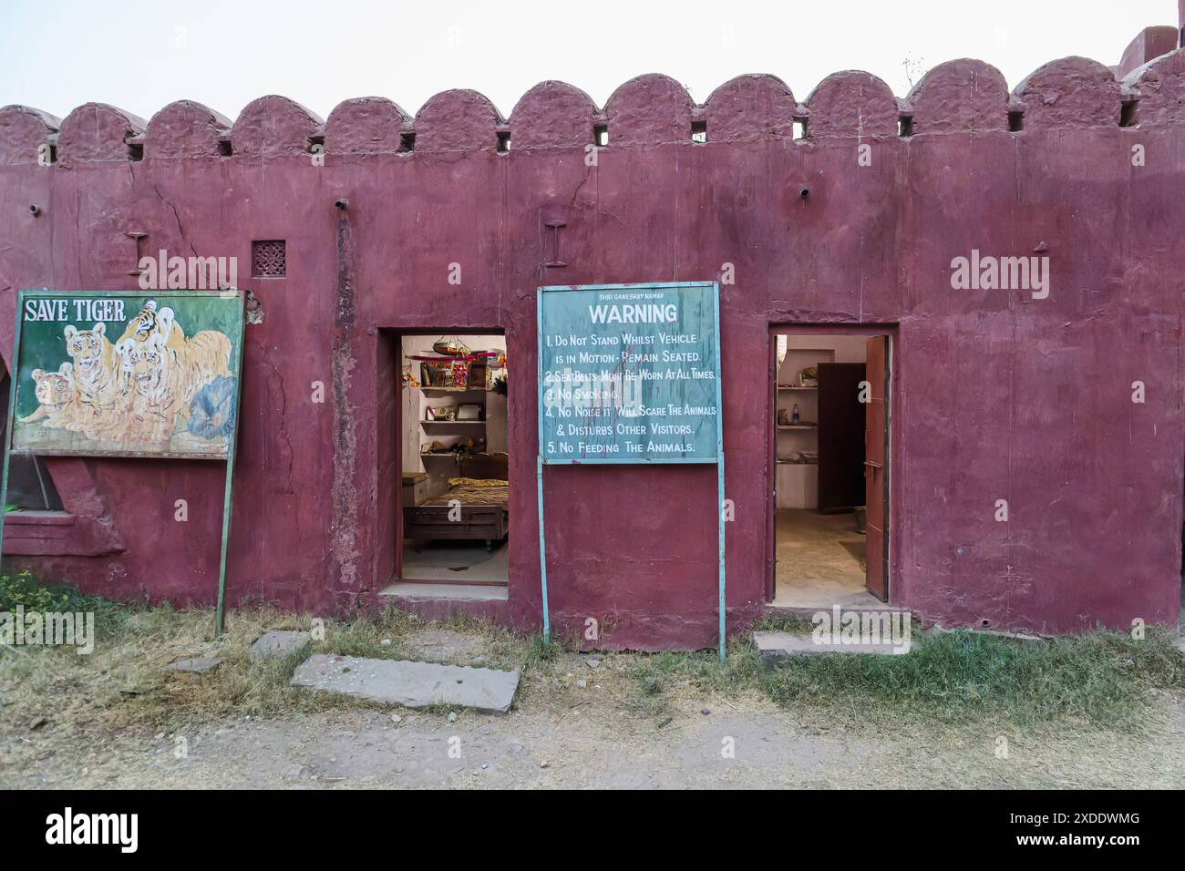 Safari behaviour warning sign and a faded 'Save Tiger' painting sign at ...