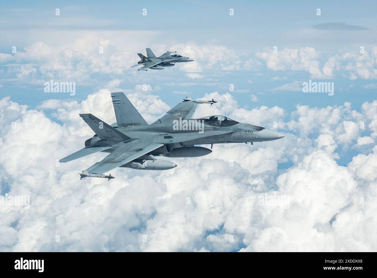 North American Aerospace Defense Command CF-18 Hornets fly in formation ...