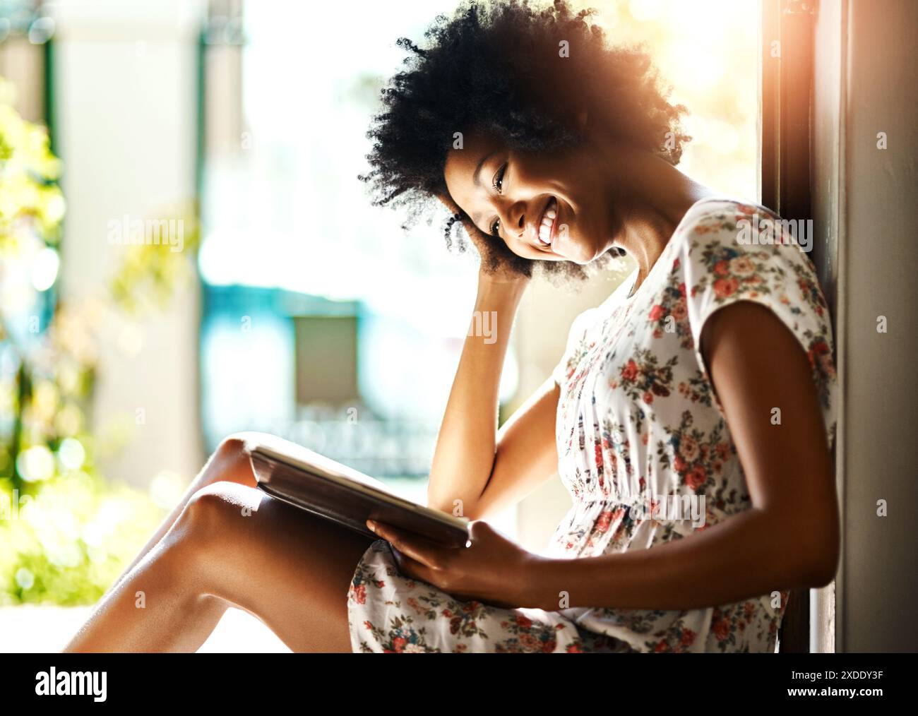 African woman, reading book and smile by window, sunshine and relax ...