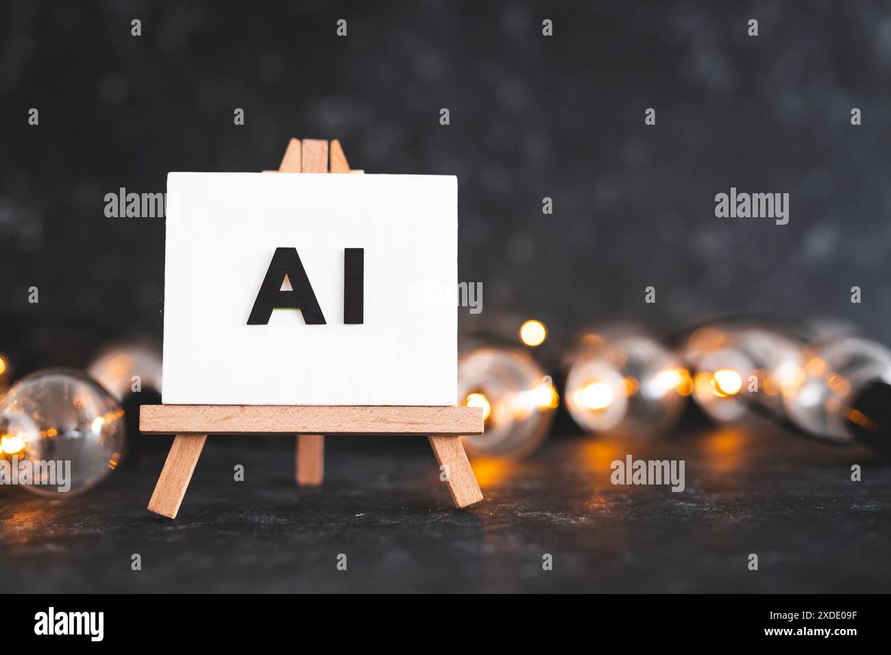 AI text on canvas on easel with light bulbs around it, art and machine ...