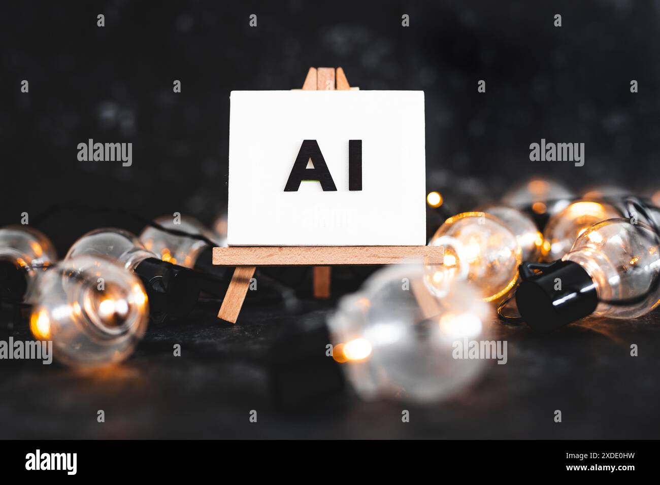 AI text on canvas on easel with light bulbs around it, art and machine ...