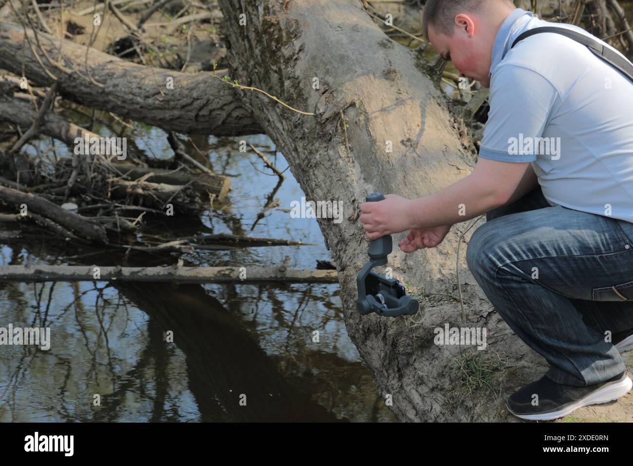A young man videotaping on a smartphone. Uses gimbal to get smooth ...