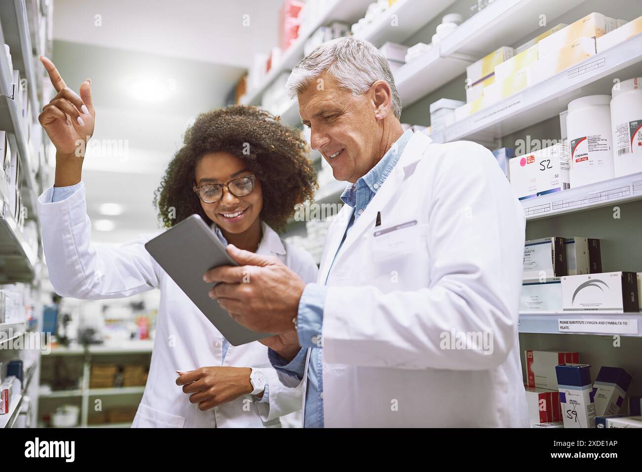 Tablet, conversation and pharmacists with medication in chemist for ...