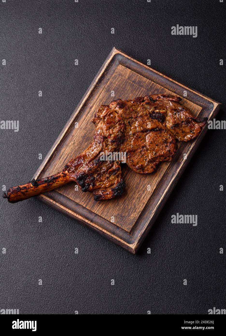Juicy beef tomahawk steak on the bone baked on the grill with salt and ...