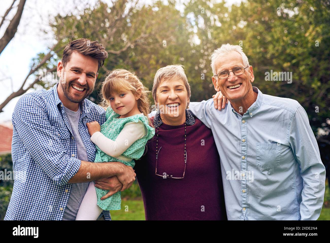 Outdoor, happy and portrait of family with hug, connection and bonding ...