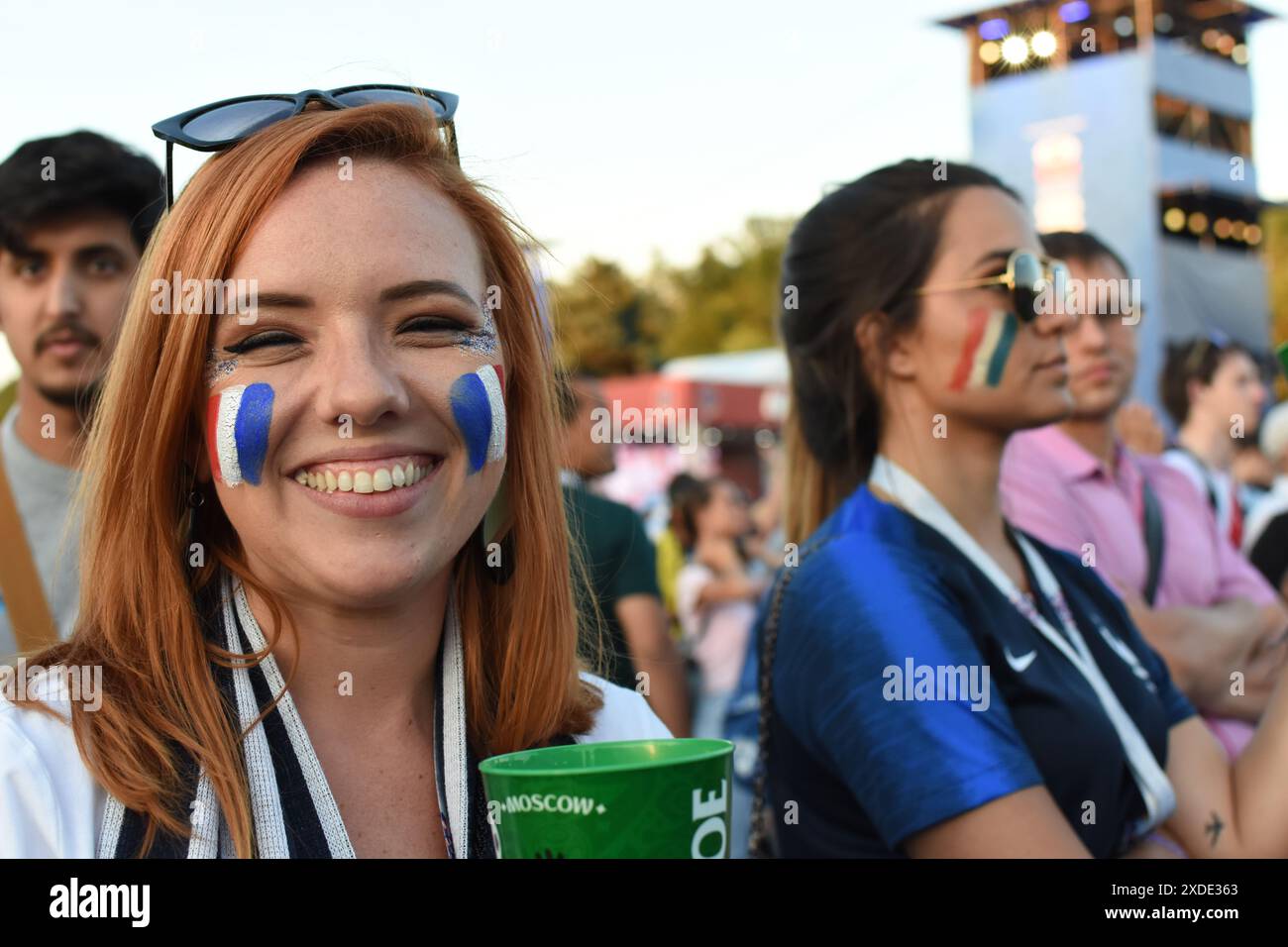 French girl drinking with flag painted on her face at the FIFA Fan Fest ...